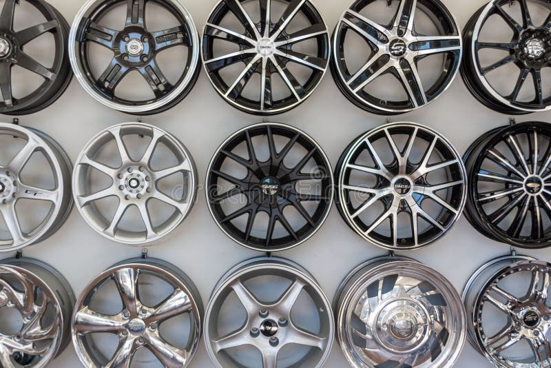 View of Different Types of Vehicle Rims on the White Wall Editorial ...