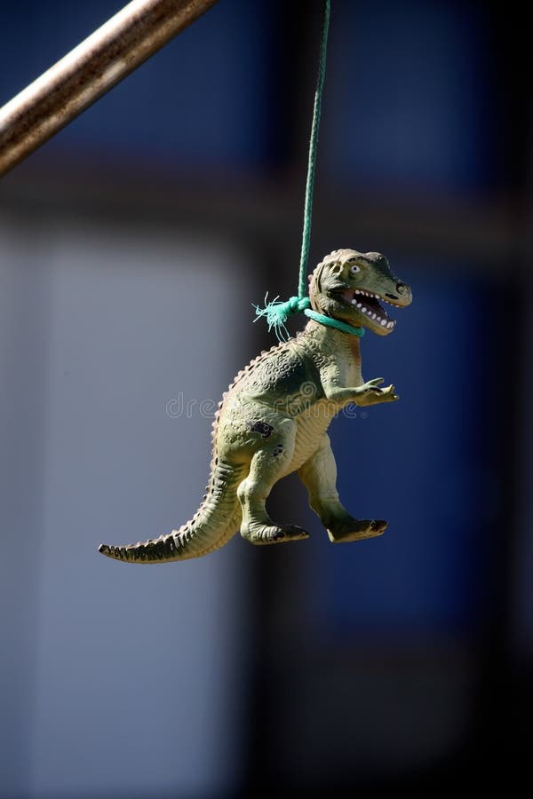 Toy hanging on thread stock photo. Image of dinosaur - 105979644