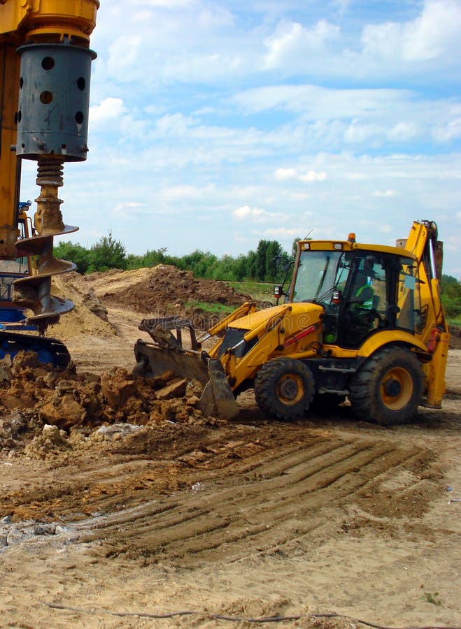 Drilling Machinery and Backhoe Stock Photo - Image of derrick ...