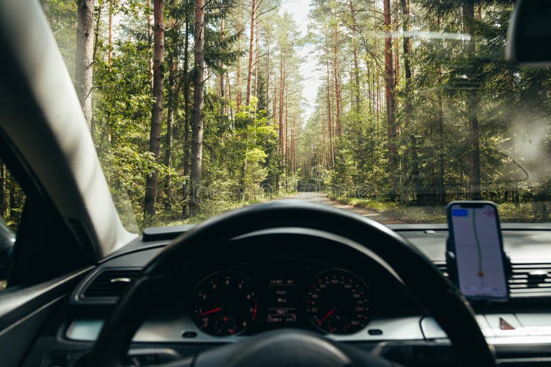 View from Driver on Car Dashboard with Navigation on Smartphone Screen ...