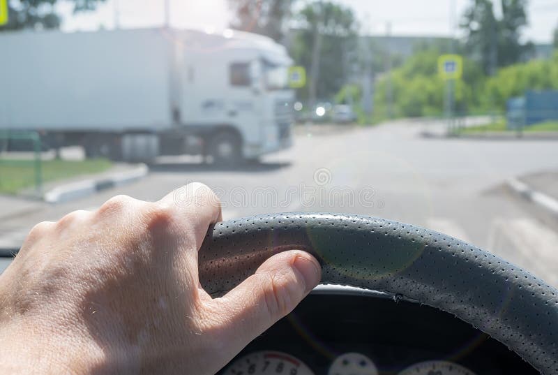 View of the Driver Hand at the Wheel of a Car at a Road Stock Photo ...