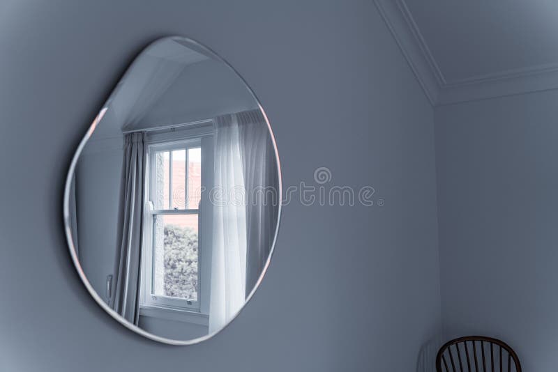 View of a Drop-shaped Mirror on the White Wall of a Room Stock Image ...