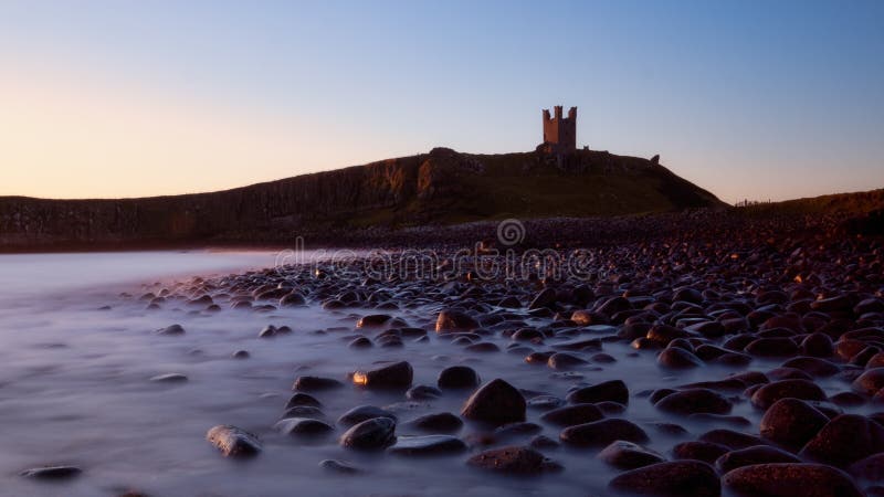 Dunstanburgh Castle at Dusk Stock Photo - Image of shore, seascape ...