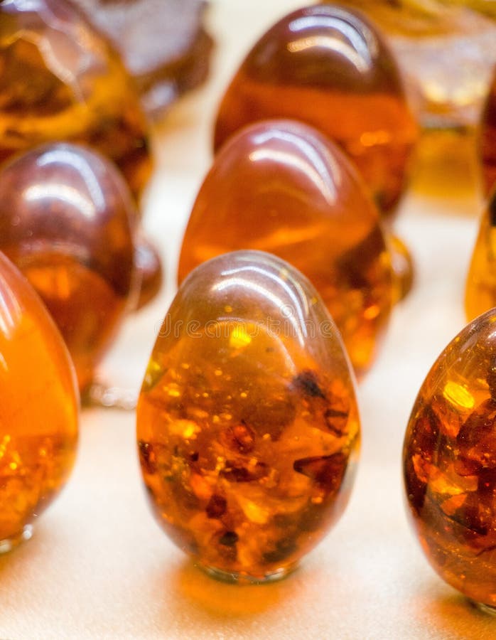 View of Egg-shaped Transparent Brown Objects Placed on a White Surface ...