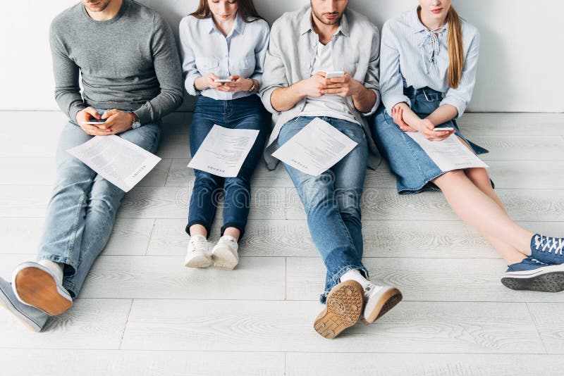 View of Employees with Resume Using Smartphones on Floor Stock Photo ...