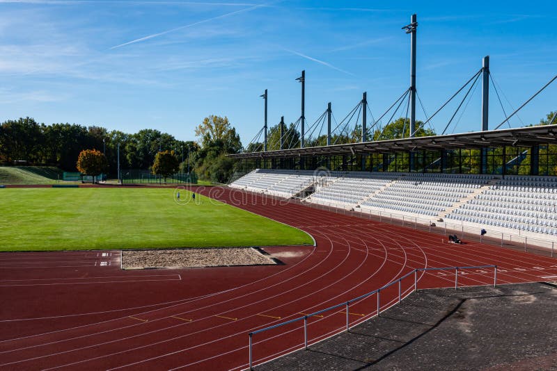 View of the Empty Stands of the Stadium with a Green Field and a ...