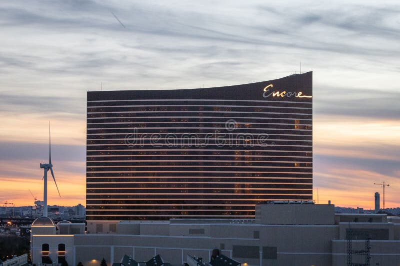 View of Encore Boston Casino at Sunset with a Wind Turbine in the ...