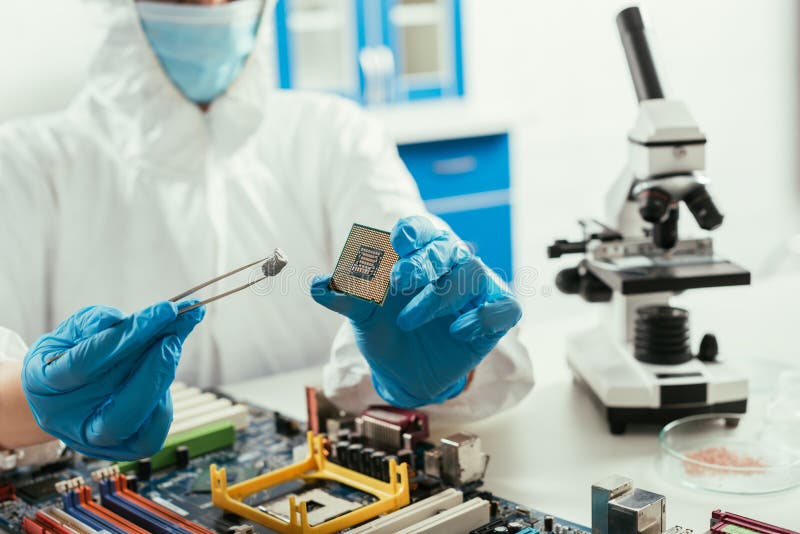 View of Engineer Holding Microchip and Small Stone Near Microscope and ...