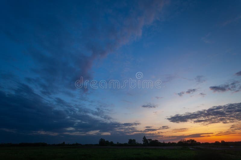 View of Evening Clouds and Sky after Sunset Over a Meadow Stock Photo ...