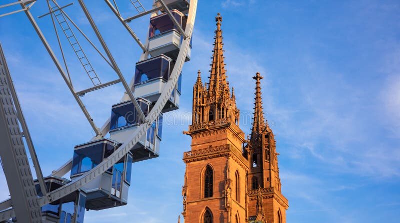 View of a Ferris Wheel and Clock Tower of the Basel Minster during Fall ...