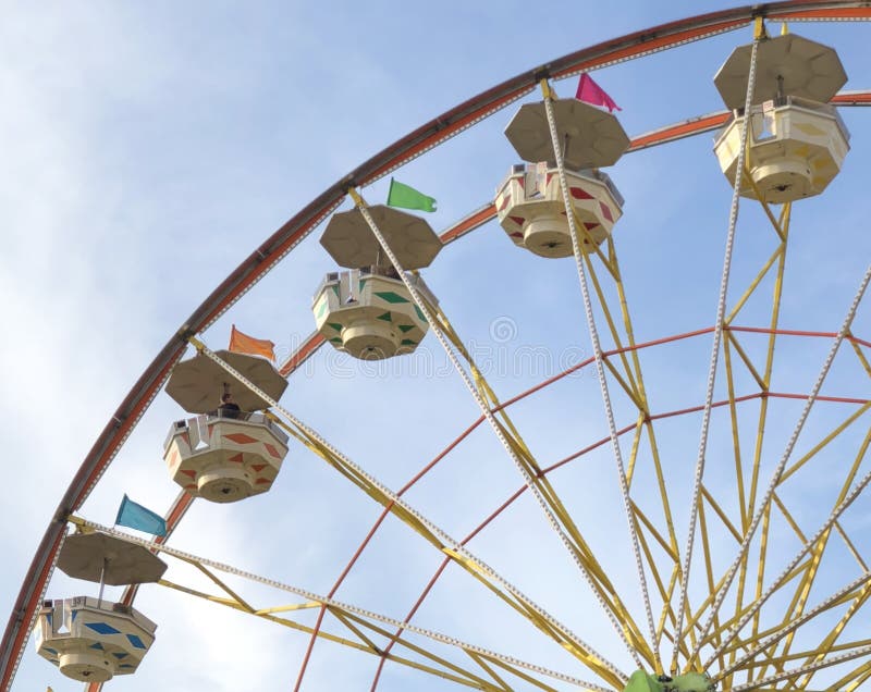 View of Ferris wheel stock photo. Image of riders, flags - 180953110
