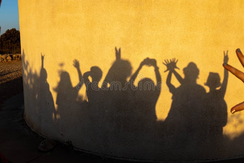 View of a Fun Photo of Group of Friends Making Poses Creating a Shadow ...