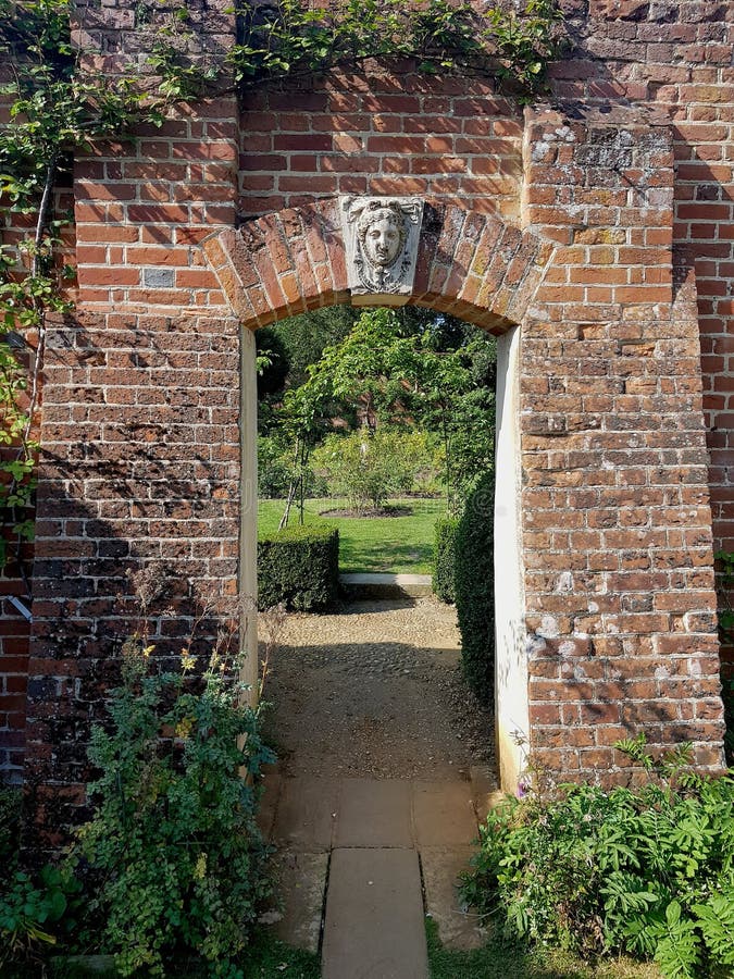 A View through a Gateway in a Red Brick Wall To a Garden Beyond. Stock ...