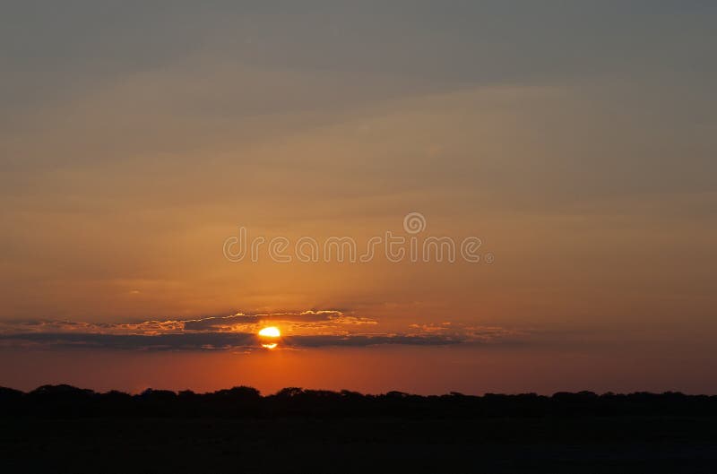 GLOWING SUN GOING DOWN in an AFRICAN LANDSCAPE Stock Image - Image of ...