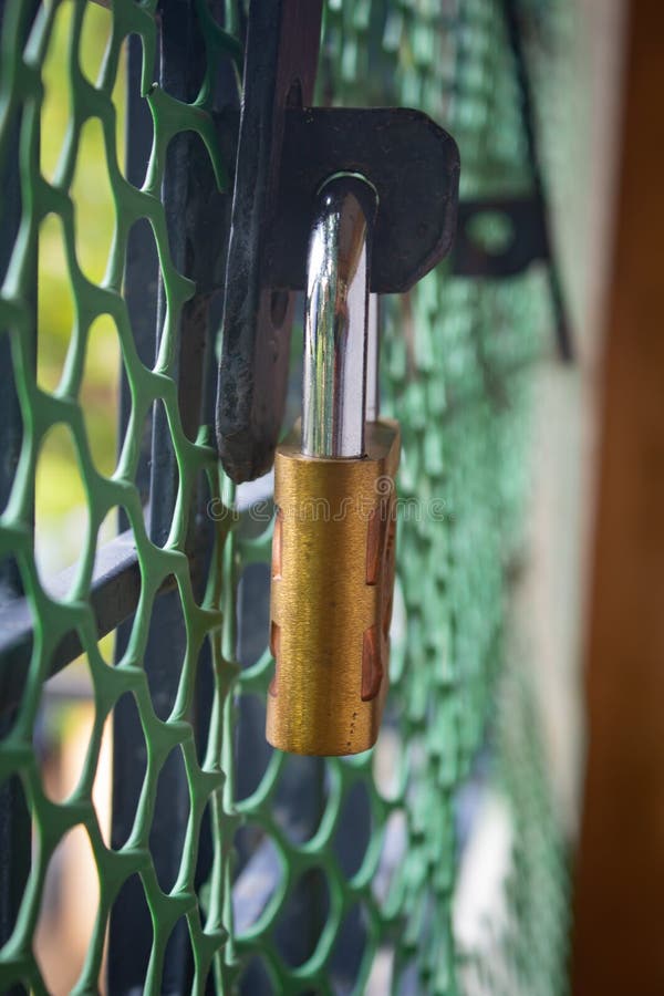 View of a Golden Color Lock on a Iron Grill for Safety Stock Photo ...