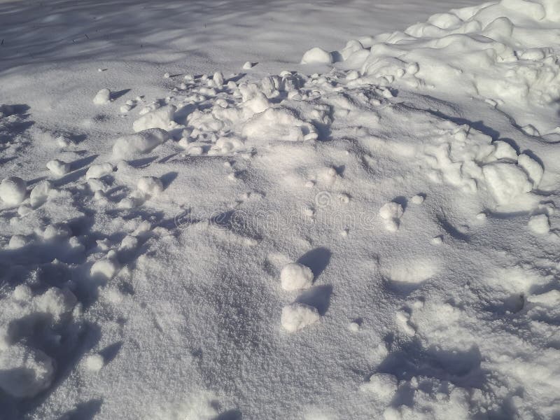 View of Ground Covered with Piles of White Snow in Sunlight in Winter ...
