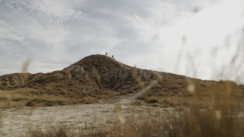View from the Ground of a Mountain with Two People on Top of it Stock ...
