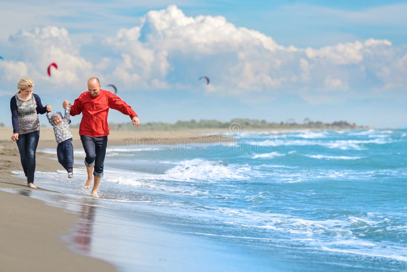 View of Happy Young Family Having Fun on the Beach Stock Photo - Image ...