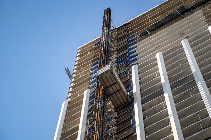 View of High Rise Building Under Construction with External Elevator ...