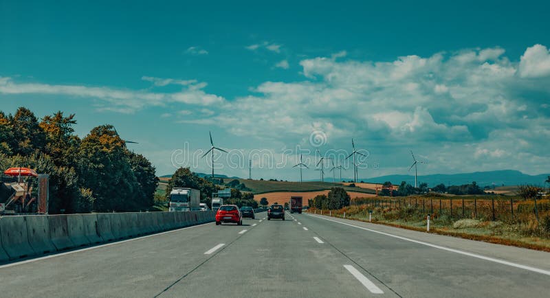 View of the Highway and Field with Wind Turbines Stock Image - Image of ...