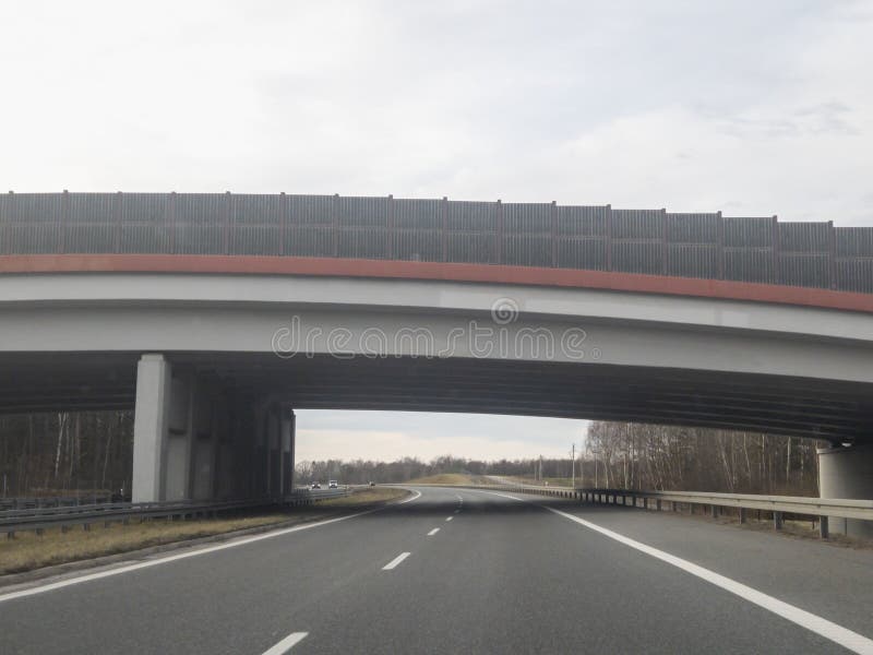 A View of a Highway Under a Modern Overpass with a Clear Sky ...