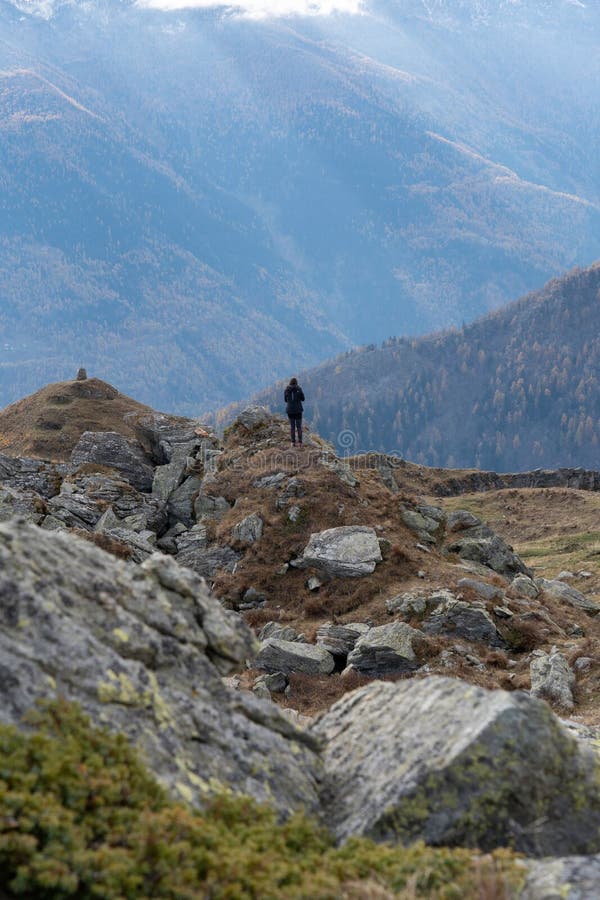 View of a Hiker Standing on the Mountain and Watching the Valley Below ...
