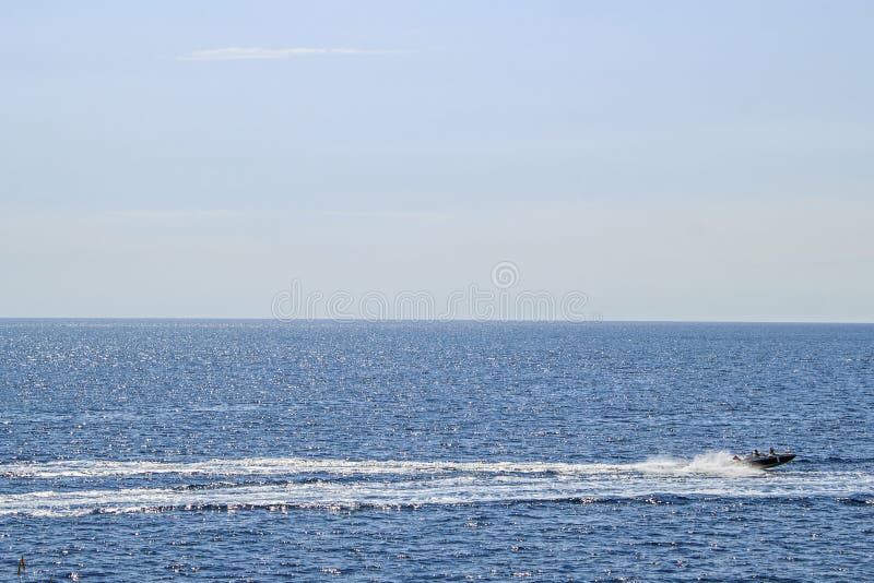 View on Horizon and Open Sea with Speed Boat Passing by Stock Photo ...