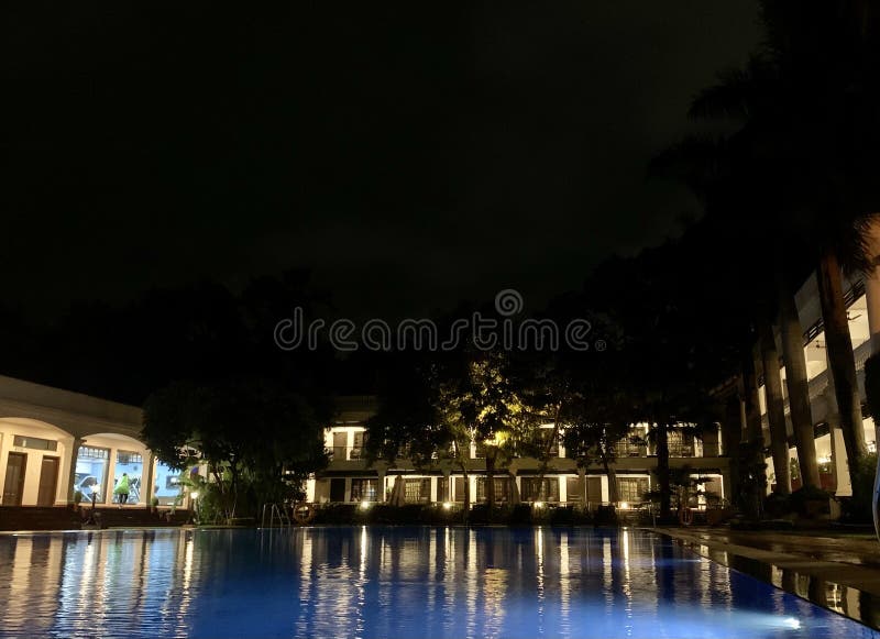 View of a Hotel with a Big Pool in Front of it at Night Stock Photo ...