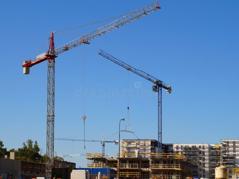 Three Cranes at Work. View of the House Construction Site. Stock Image ...