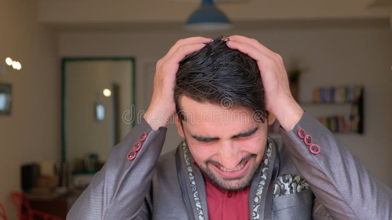 View of an Indian Guy in a Grey Jacket with a Frustrated Look in His ...