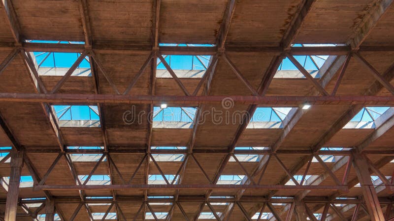 A View of an Industrial Building S Ceiling with Skylights Showcasing ...