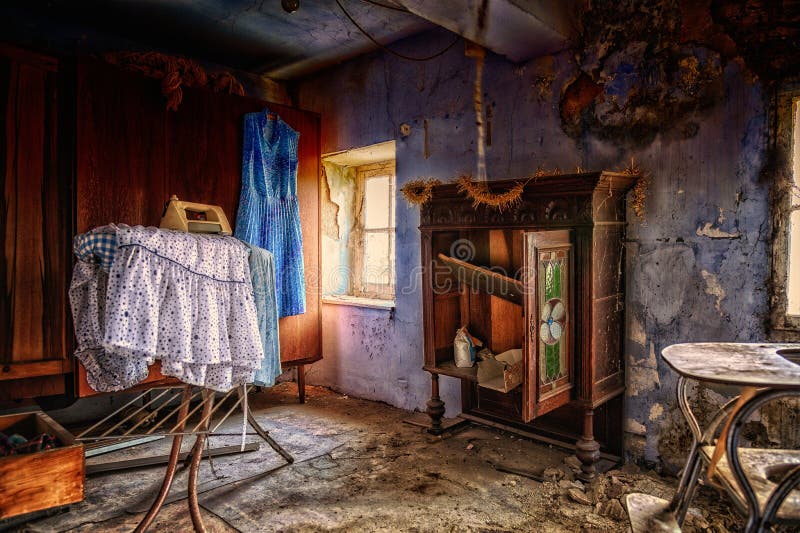 View Inside an Abandoned House with Cloths Hanged and Broken Cabinets ...