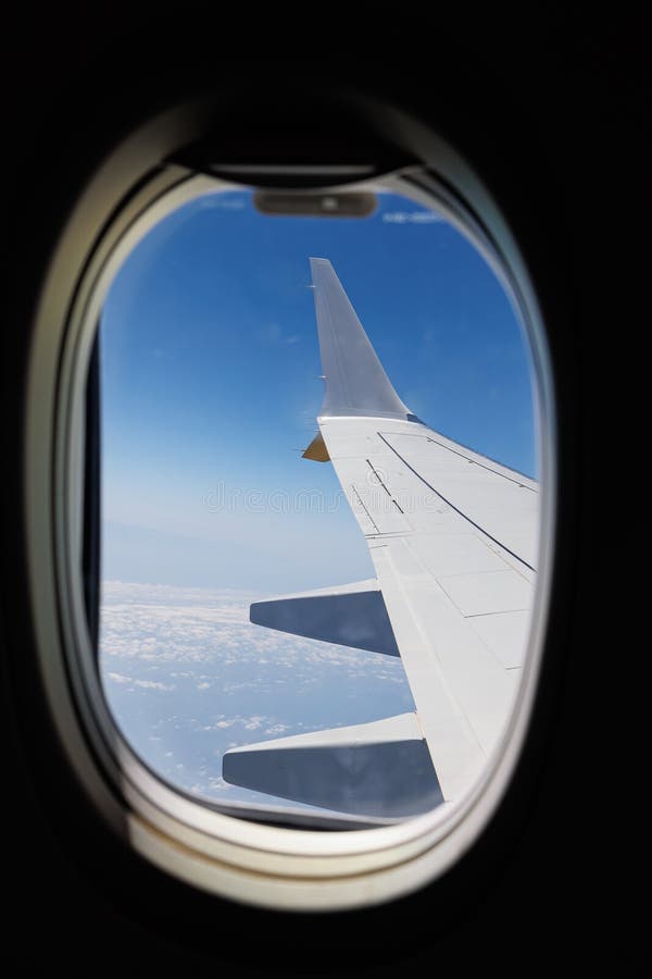 View from Inside an Aircraft: Window of the Cabin, White Airplane Wing ...