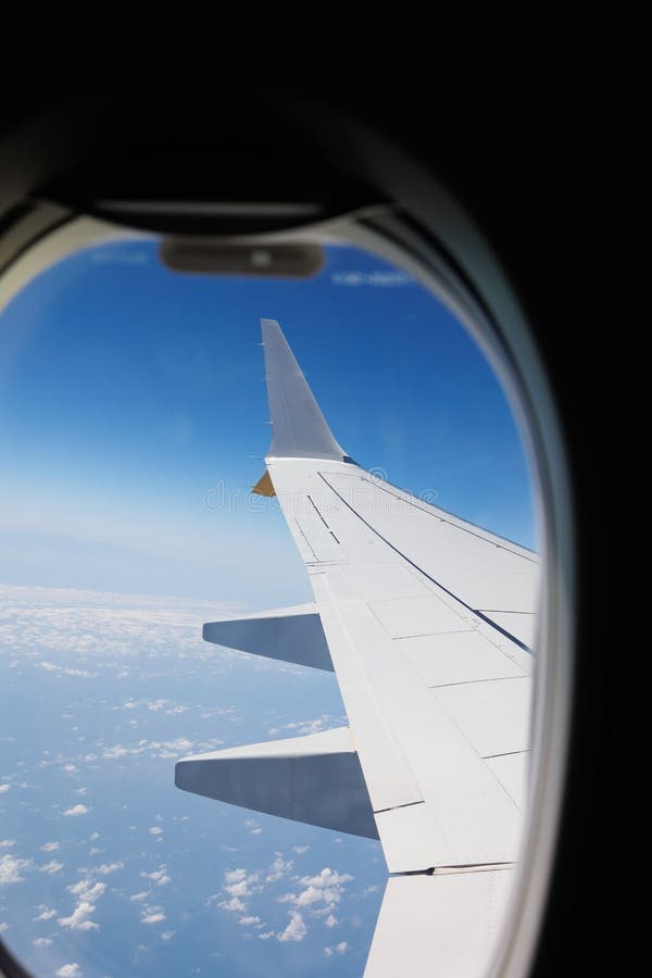 View from Inside an Aircraft: Window of the Cabin, White Airplane Wing ...