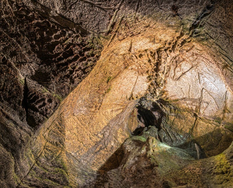 Boy Inside the Ancient Cave with Stone Walls with Additional Lighting ...