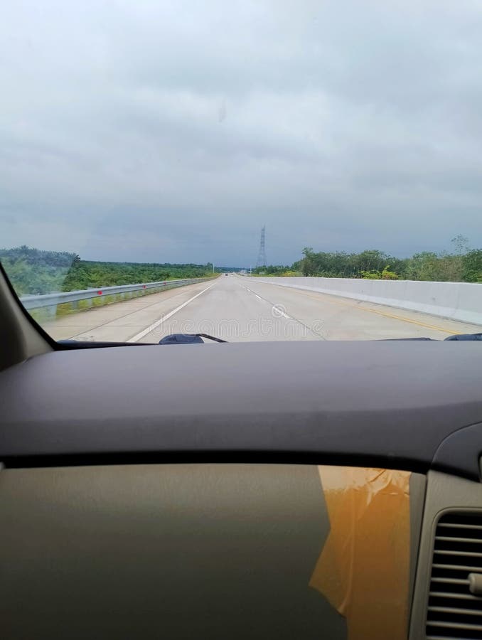 Driving View on a Highway with Gray Sky and Trees Seen from the Car Windshield Stock Photo ...