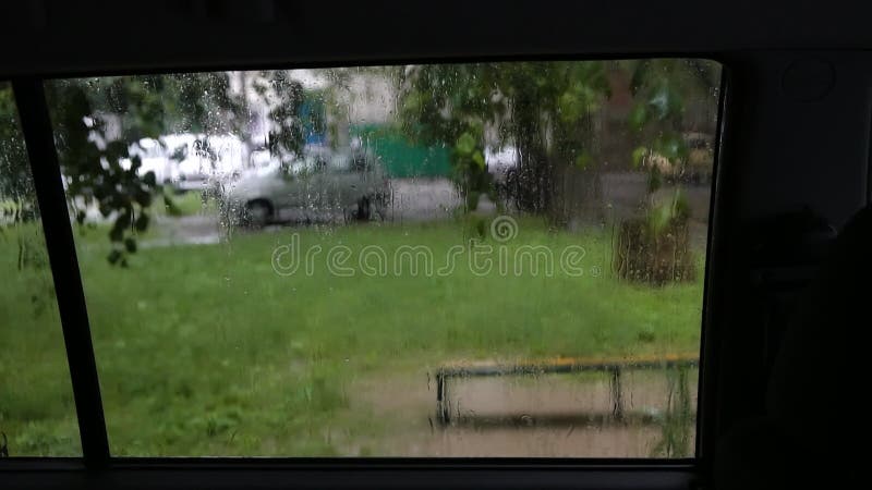 View from Inside Car through Side Window To Yard with Bench Which it is ...