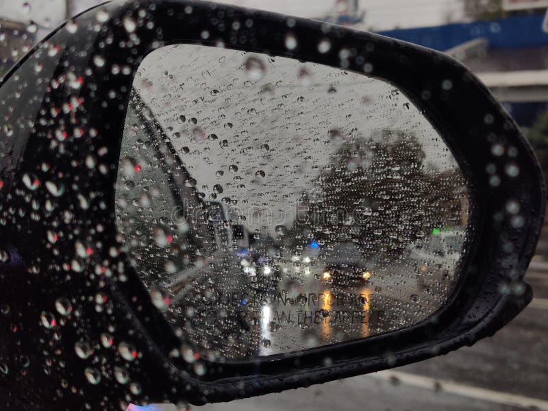 A View from Inside Car To Raindrops on Car Mirror Stock Photo - Image ...