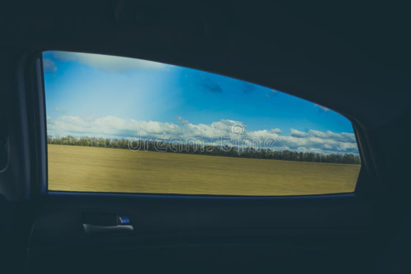 View from the Inside of the Car Window on a Field Under a Blue Sky with ...