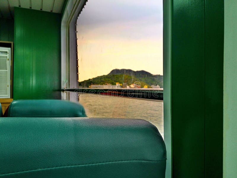View from Inside a Ferry Shows a Distant Island and Water through a ...