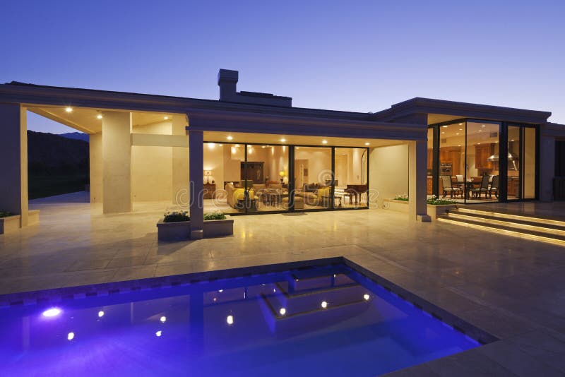 View Inside Modern Home with Swimming Pool at Dusk Stock Photo - Image ...