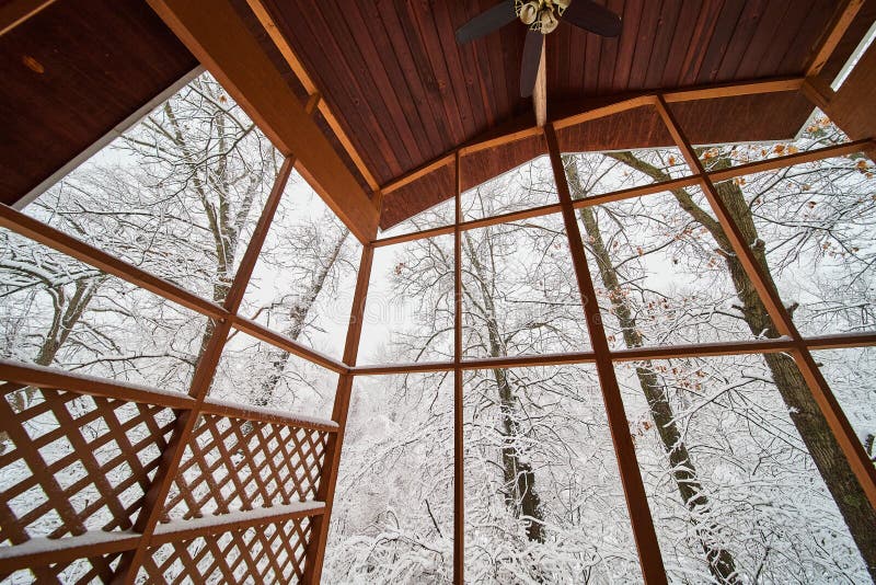 View Inside Three Season Patio in Winter with Trees Covered in Snow ...