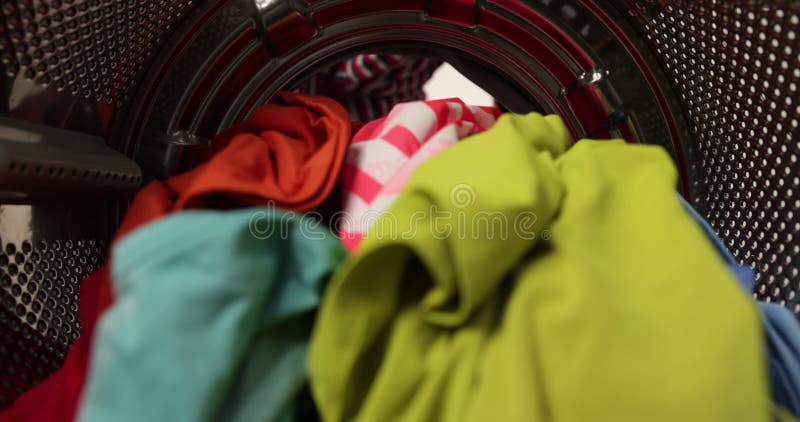 View from Inside a Washing Machine, a Man Puts a Colored Wash into the ...