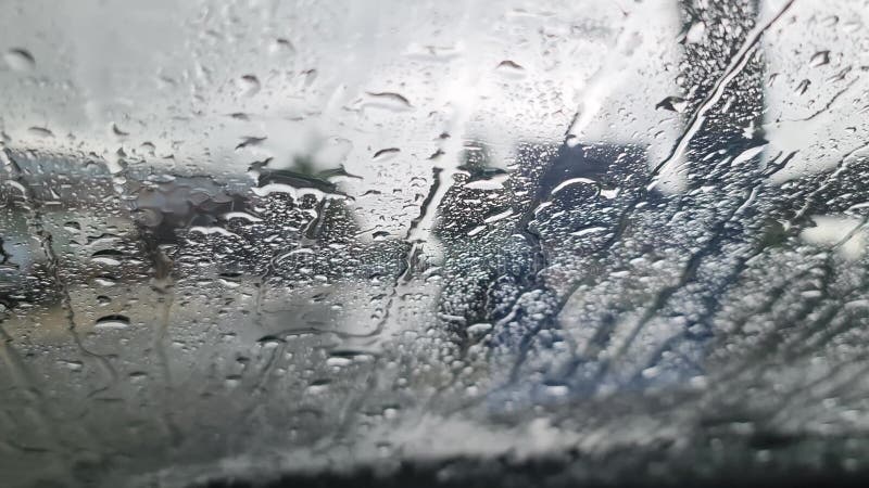 View from Inside the Windscreen of a Car in Heavy Rain with Many Drops ...