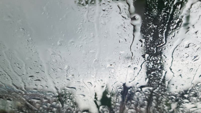 View from Inside the Windscreen of a Car in Heavy Rain with Many Drops ...