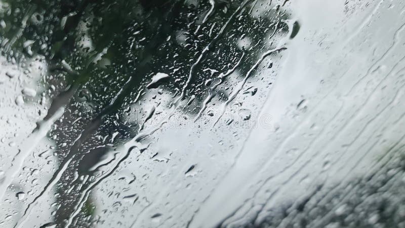 View from Inside the Windscreen of a Car in Heavy Rain with Many Drops ...