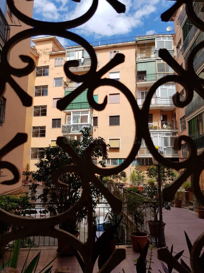 View of the Italian Courtyard through the Window Bars Stock Photo ...