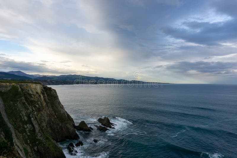 Jagged and Rocky Ocean Coast with Cliffs and a Rainbow Stock Image ...