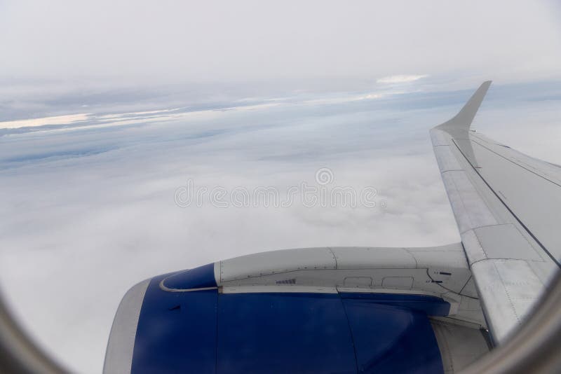 View of Jet Plane Wing on the Background of Thick Clouds and Blue Sky ...