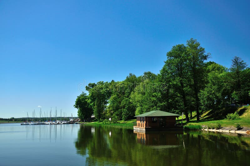View of the lake in Ryn stock image. Image of trees, summer - 74114207